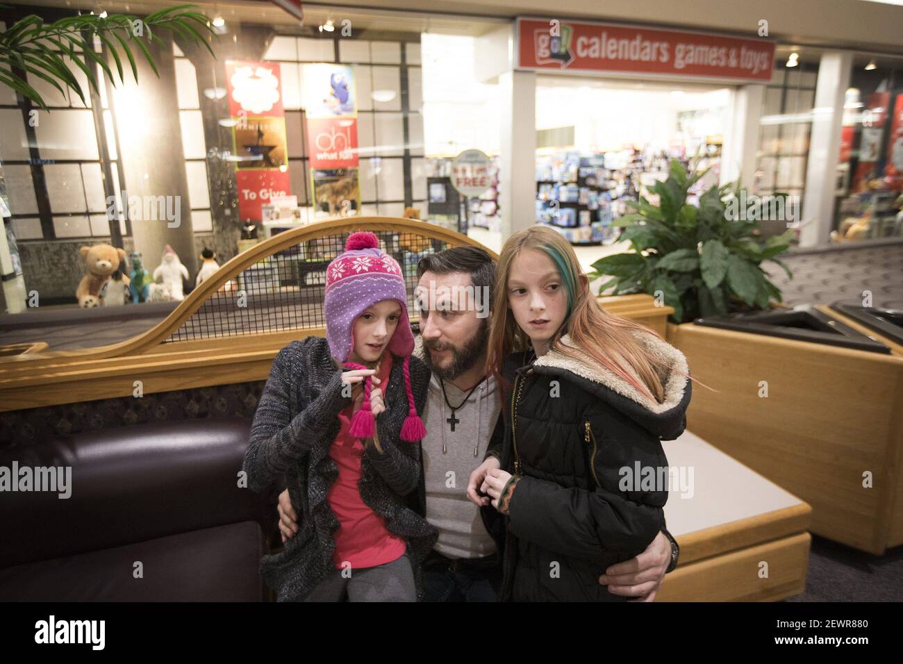 Isabelle, left, and Abby Carlsen listen as their father Jesse tells ...