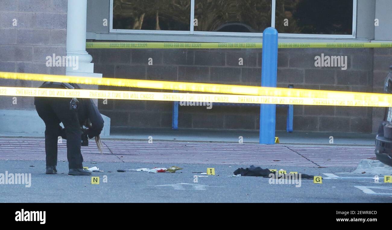 An Orlando Police crime scene technician photographs the scene Monday ...