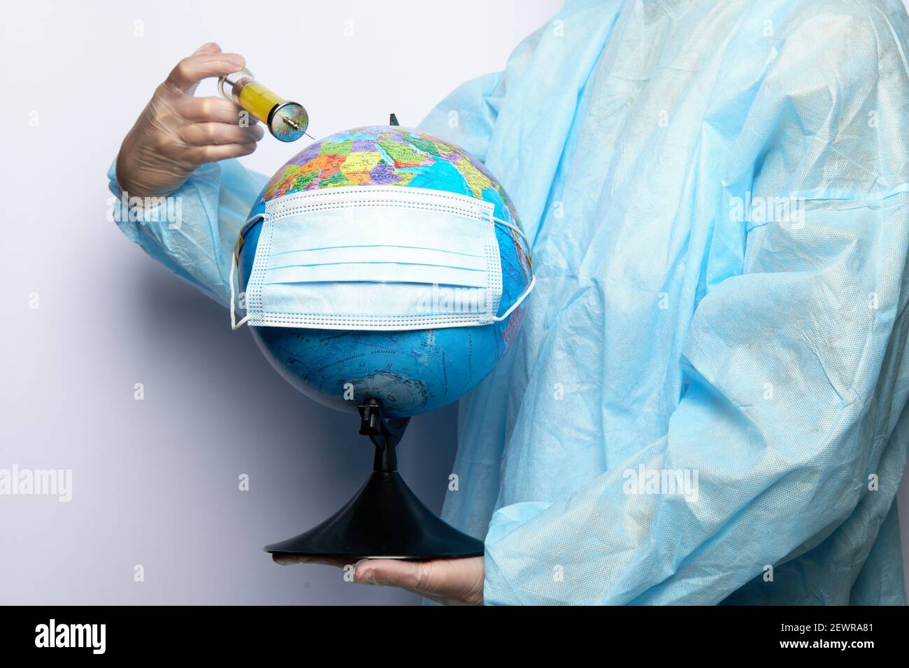 The doctor gives an injection to the globe Stock Photo - Alamy