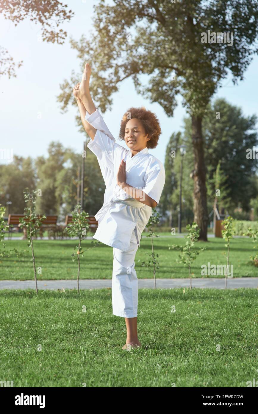 Cute female child karateka doing exercise outdoors Stock Photo - Alamy