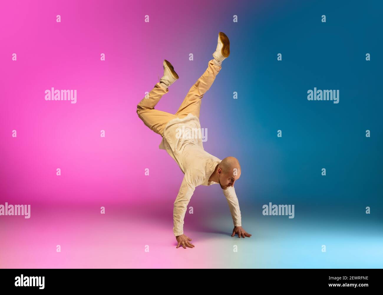 Breakdance. Stylish sportive caucasian man dancing hip-hop on colorful ...