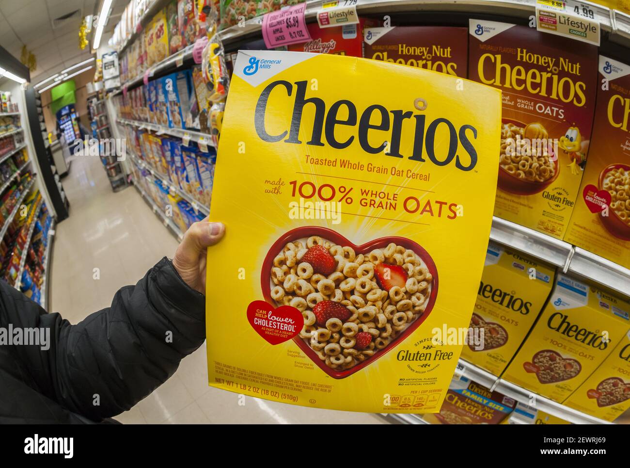 A shopper chooses a package of General Mills' Cheerios breakfast cereal ...