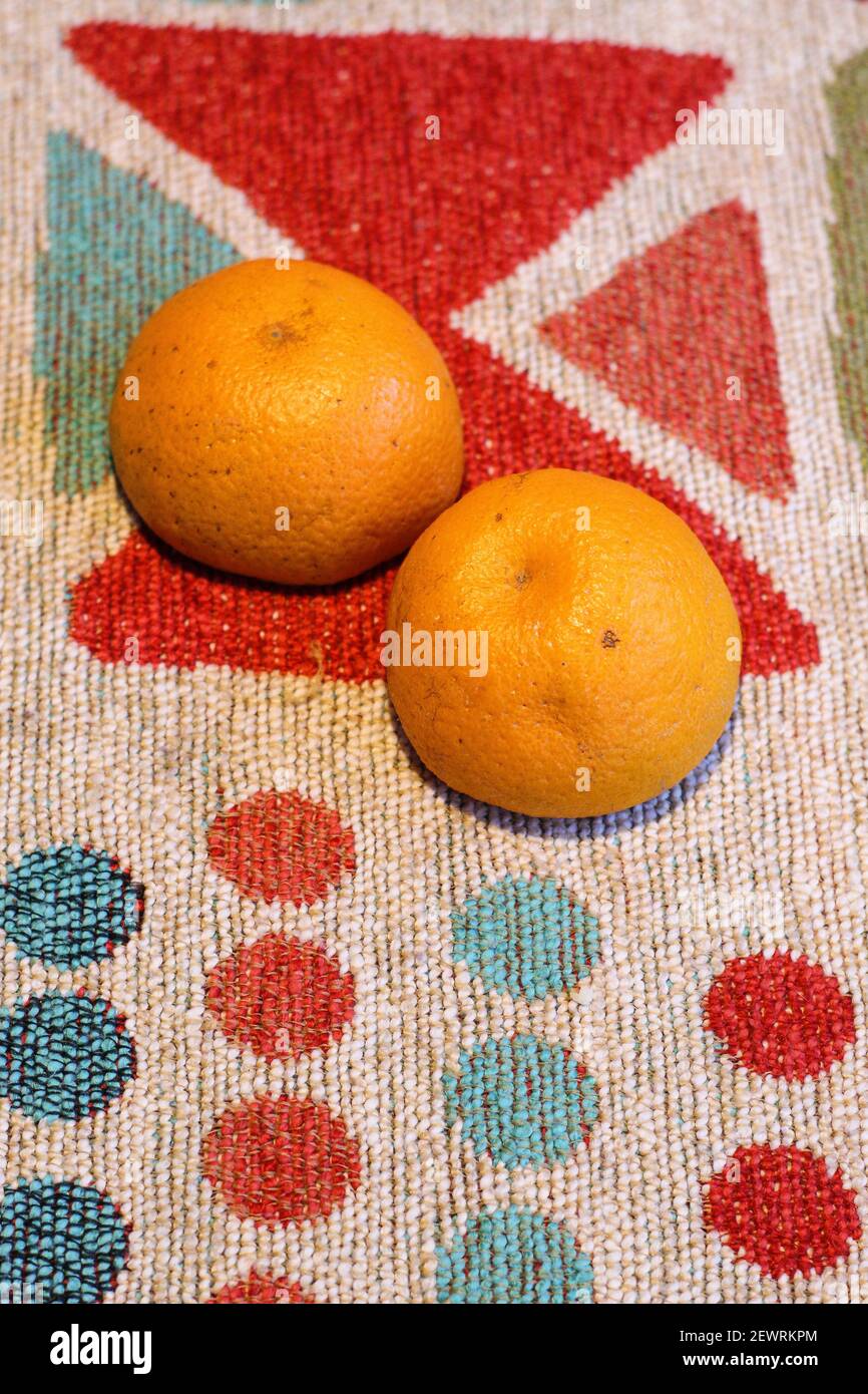 A vertical shot of mandarin oranges on a colorful artsy surface Stock ...