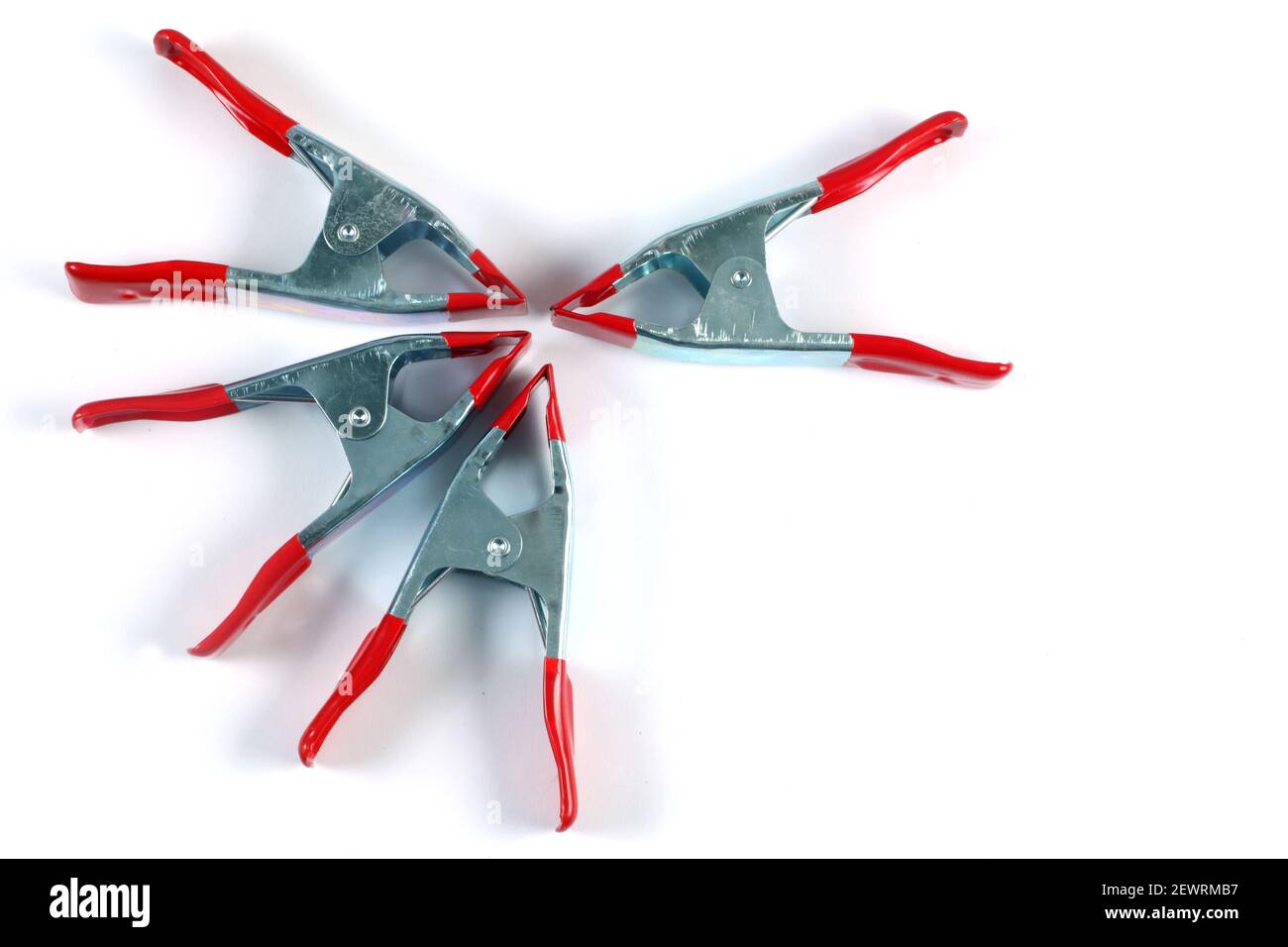 The metal spring clamps with red plastic handles and tip isolated on ...