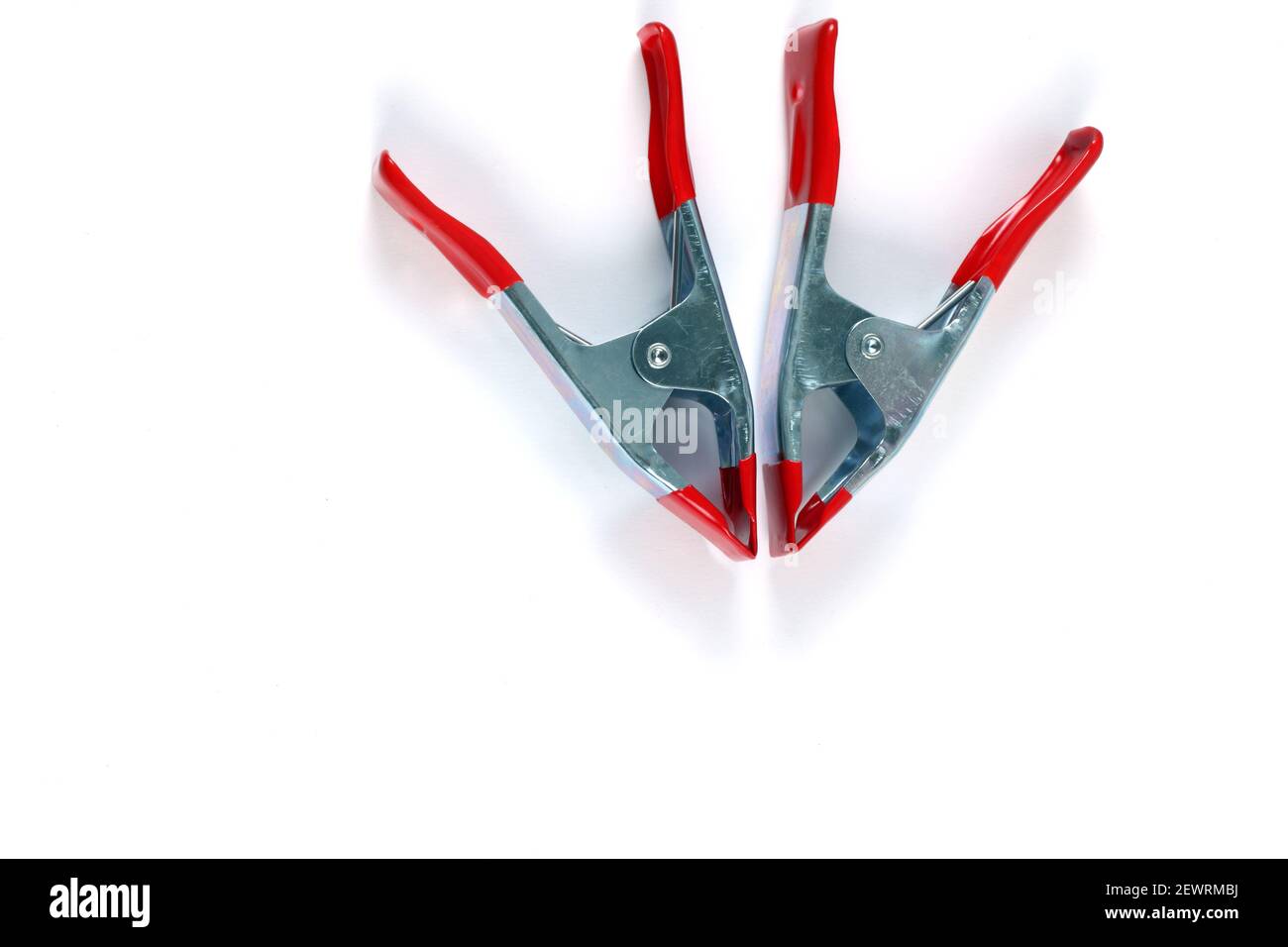 The metal spring clamps with red plastic handles and tip isolated on ...