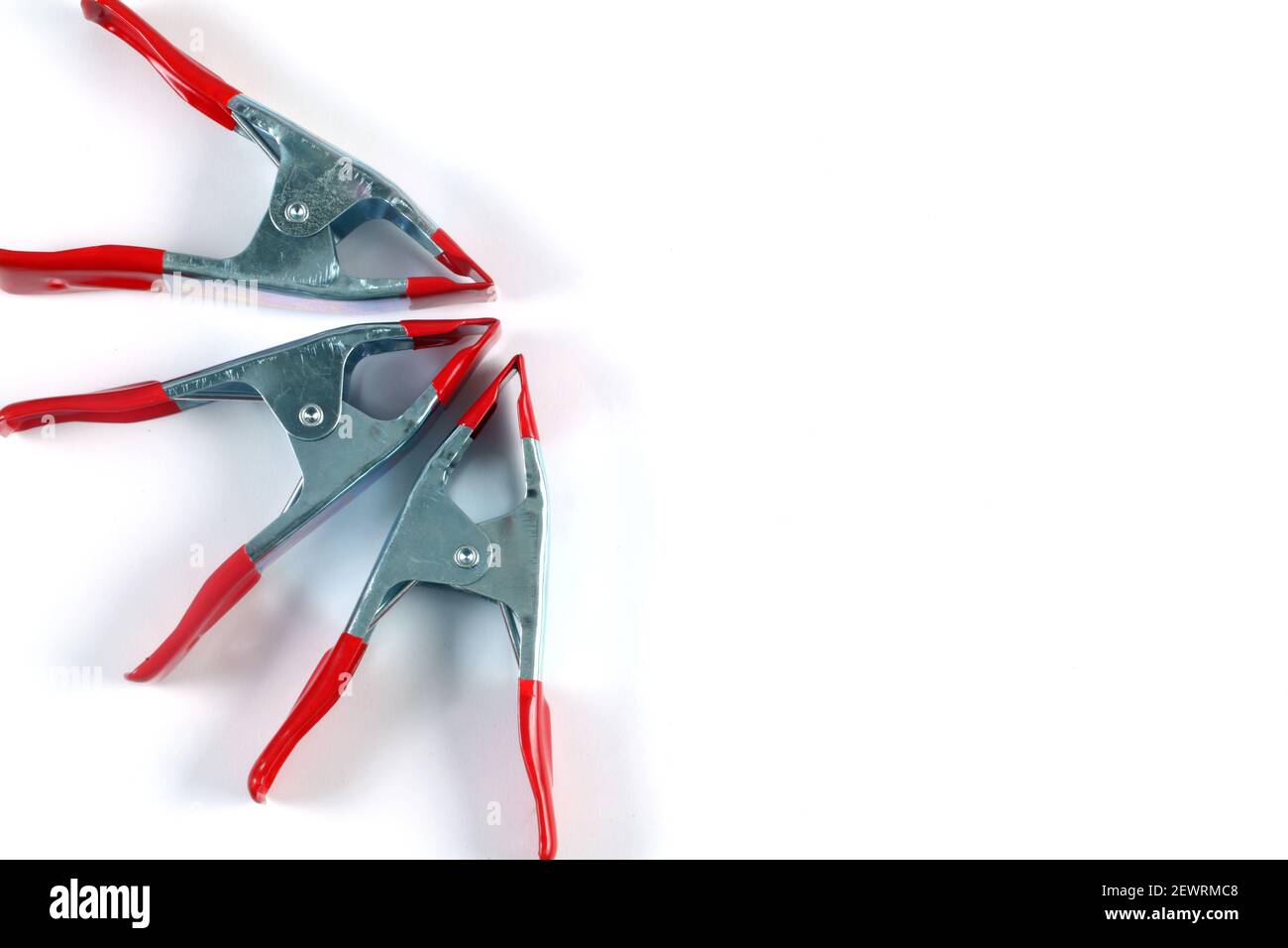 The metal spring clamps with red plastic handles and tip isolated on ...