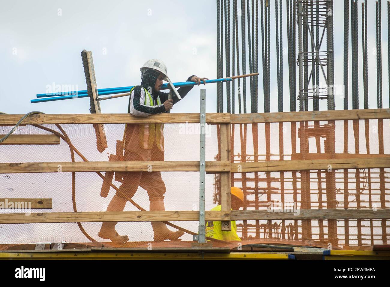A construction worker walks on the top of the construction site of a ...