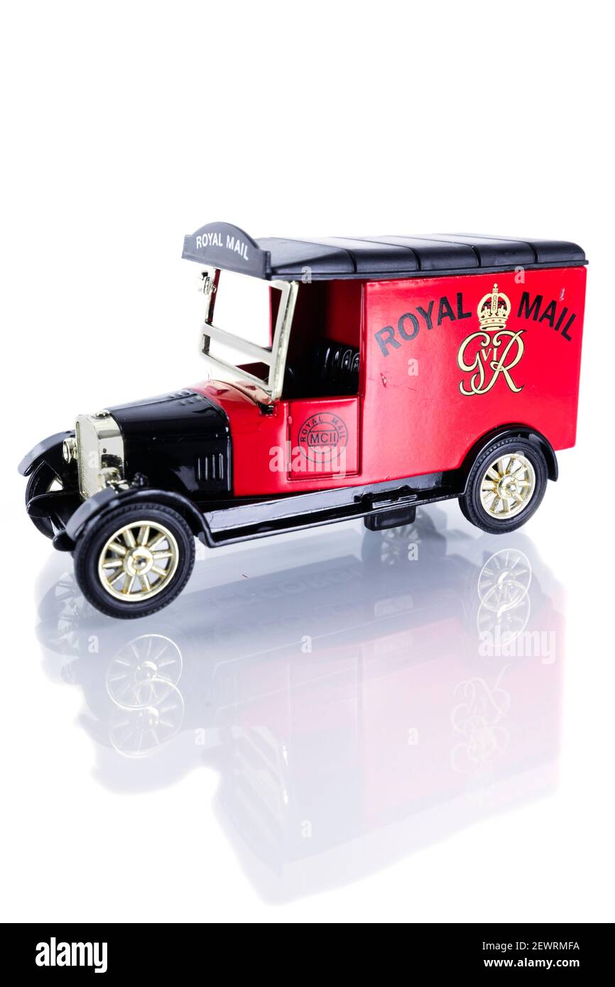Worn diecast model of a Royal Mail van. Isolated on a white background ...