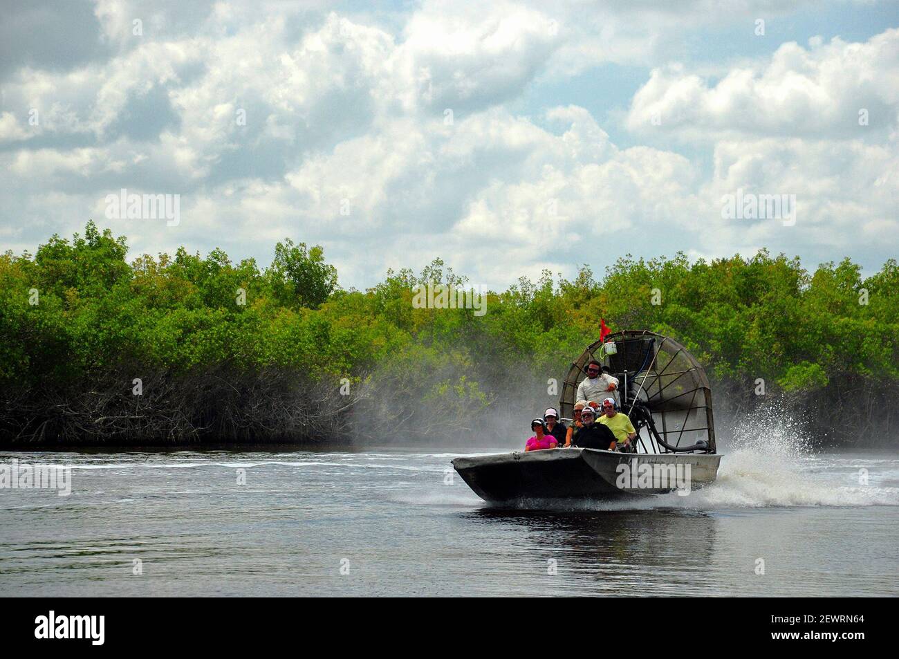 Airboats skim over the Florida Everglades, a vast wetland flowing from ...