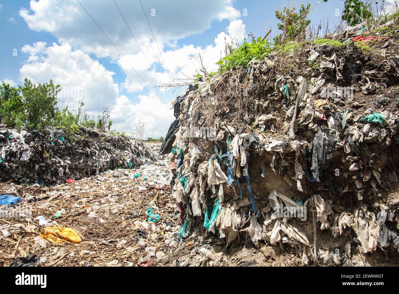 Plastic waste scattered on the ground at a local landfill in the ...