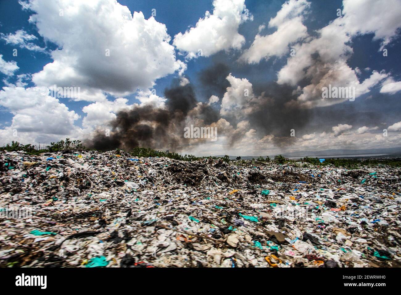 Smoke from burning waste mostly plastic rising in the sky at a local ...