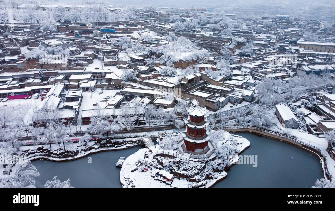 Aerial photos of a thousand-year-old ancient village scenic spot after snow in Yangquan City ...