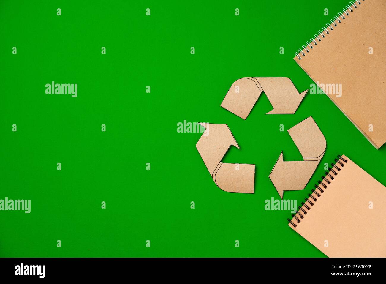 Paper recycling concept on green background top view Stock Photo - Alamy