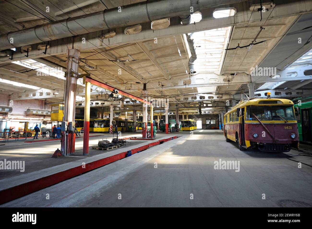 An old but still in use trolleybus parked on the inspection pit at the ...