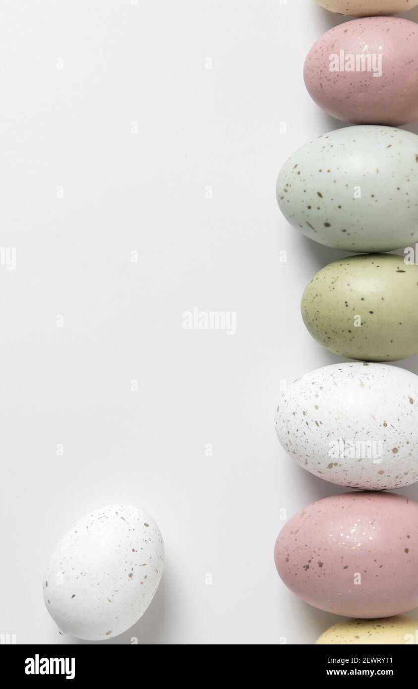 Speckled easter eggs in a vertical line with negative space for copy ...