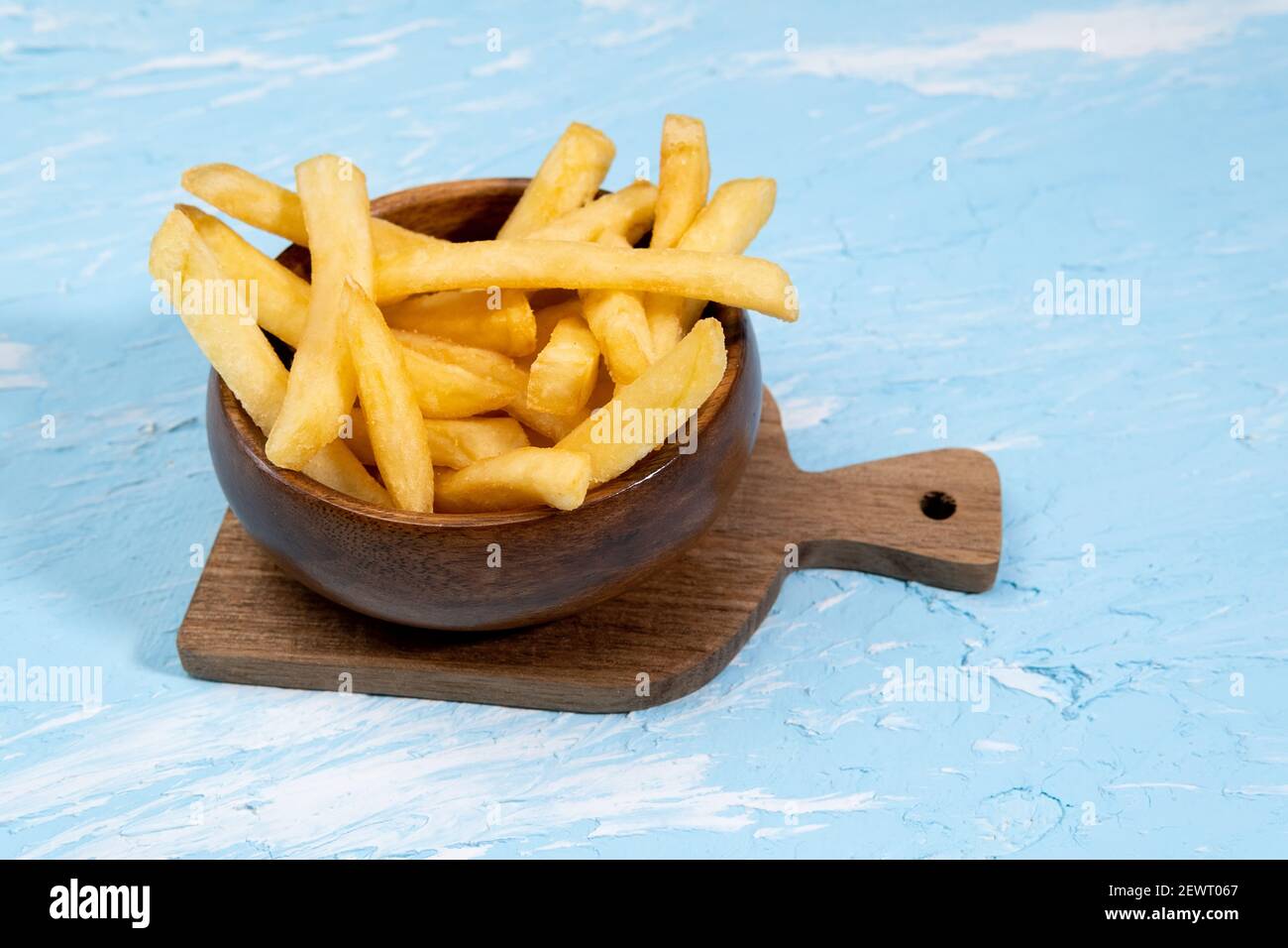 french fries on a blue background top view. space for copying text ...