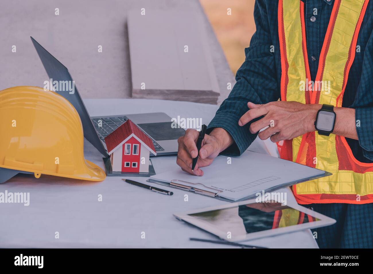Engineer working on tablet and laptop in site construction Stock Photo ...