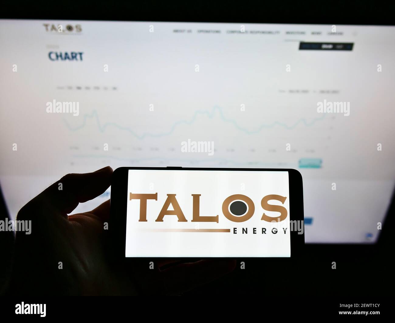 Person holding mobile phone with business logo of US oil and gas ...