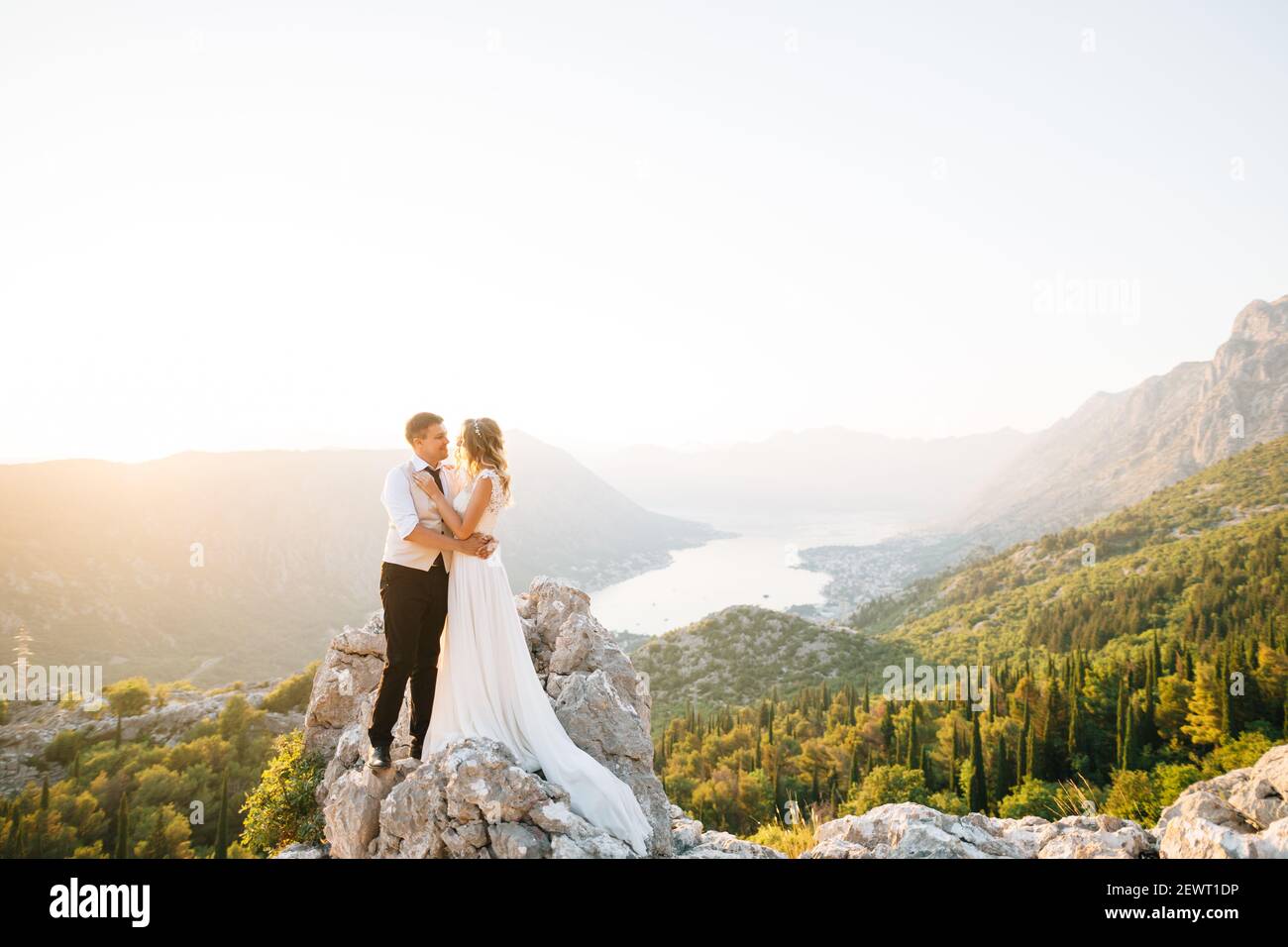 The bride and groom are embracing on Mount Lovcen, a picturesque ...