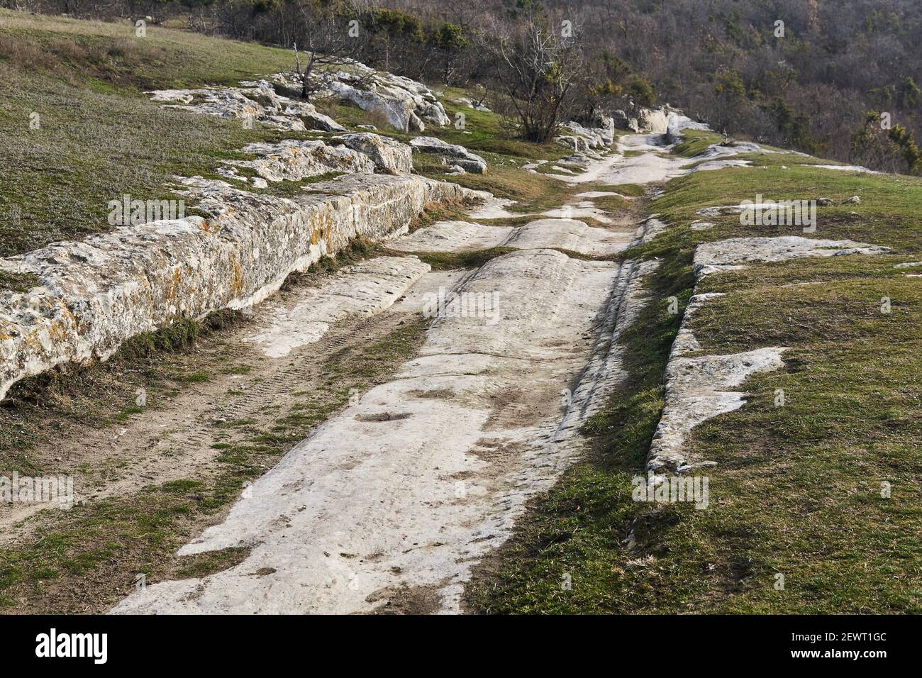 ancient mountain road with carriage ruts worn in stone for a long time ...