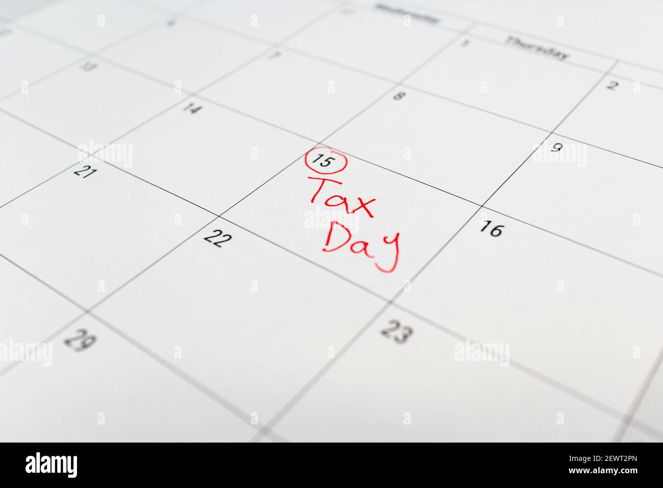 Tax day marked on April 15 calendar with red marker. Deadline for 1040 ...