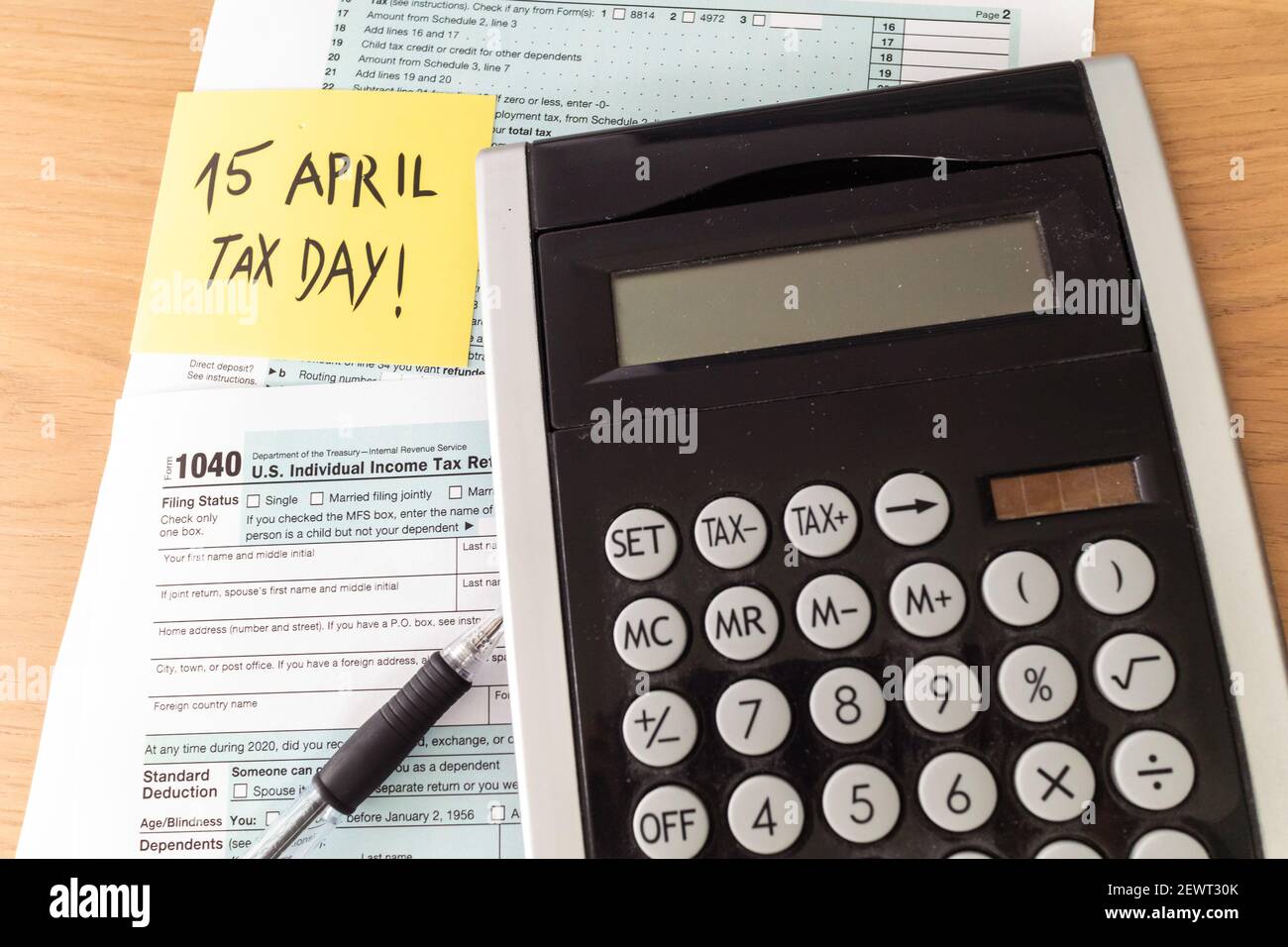Tax day. 1040 form and calculator on table ready to be filled and ...