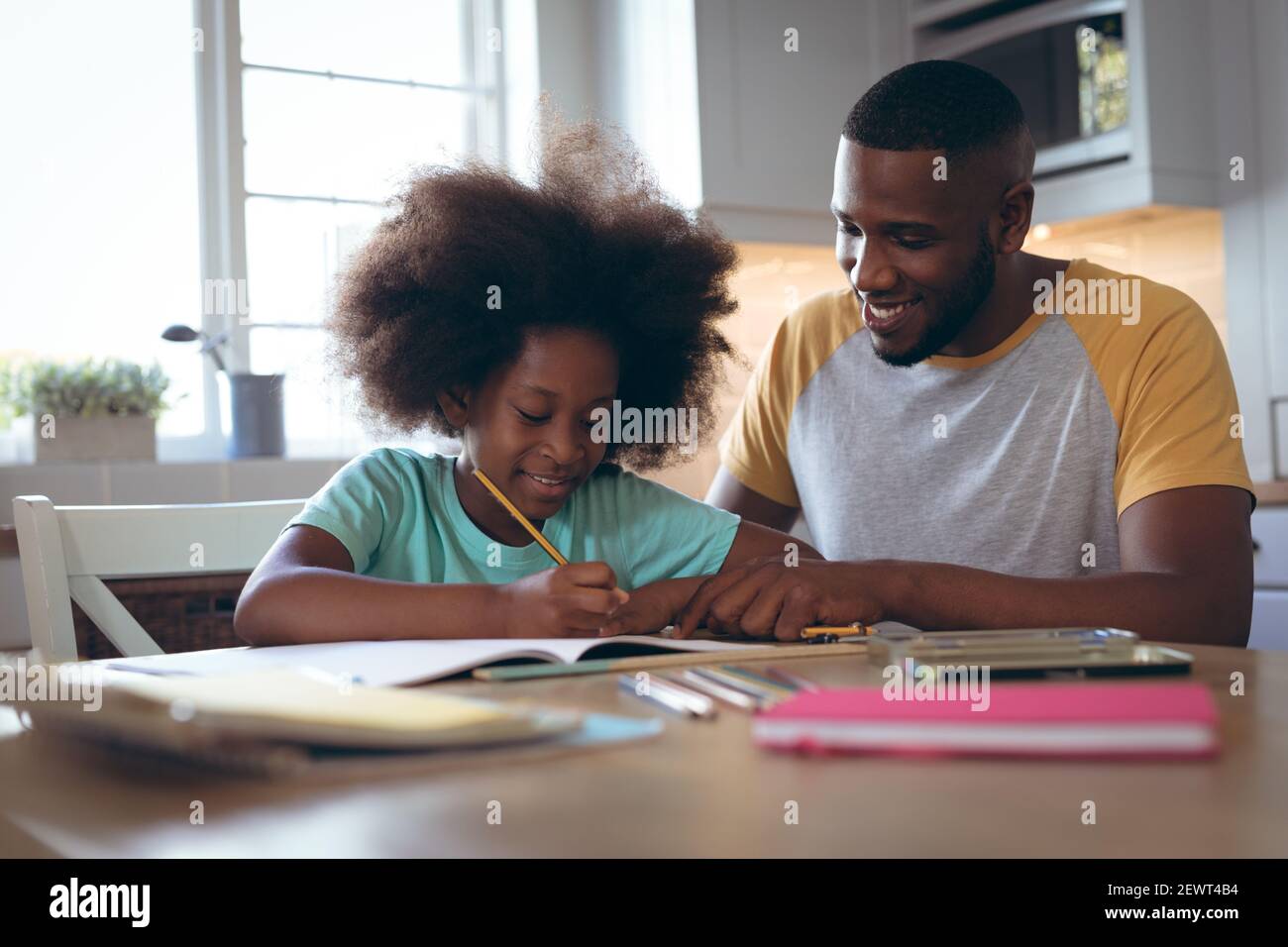 African american girl doing homework with her father Stock Photo - Alamy