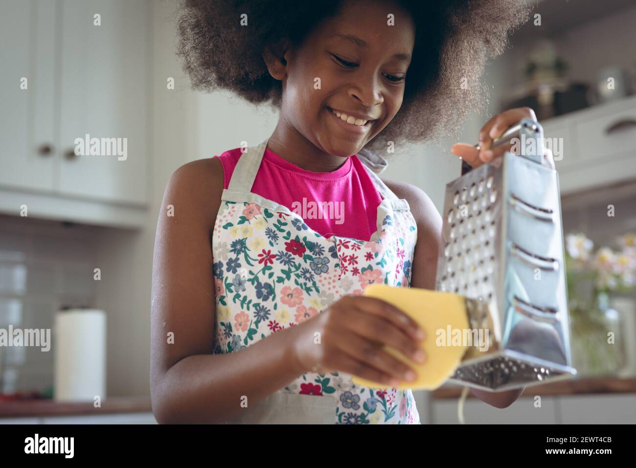 African american girl and her father making pizza together in kitchen ...