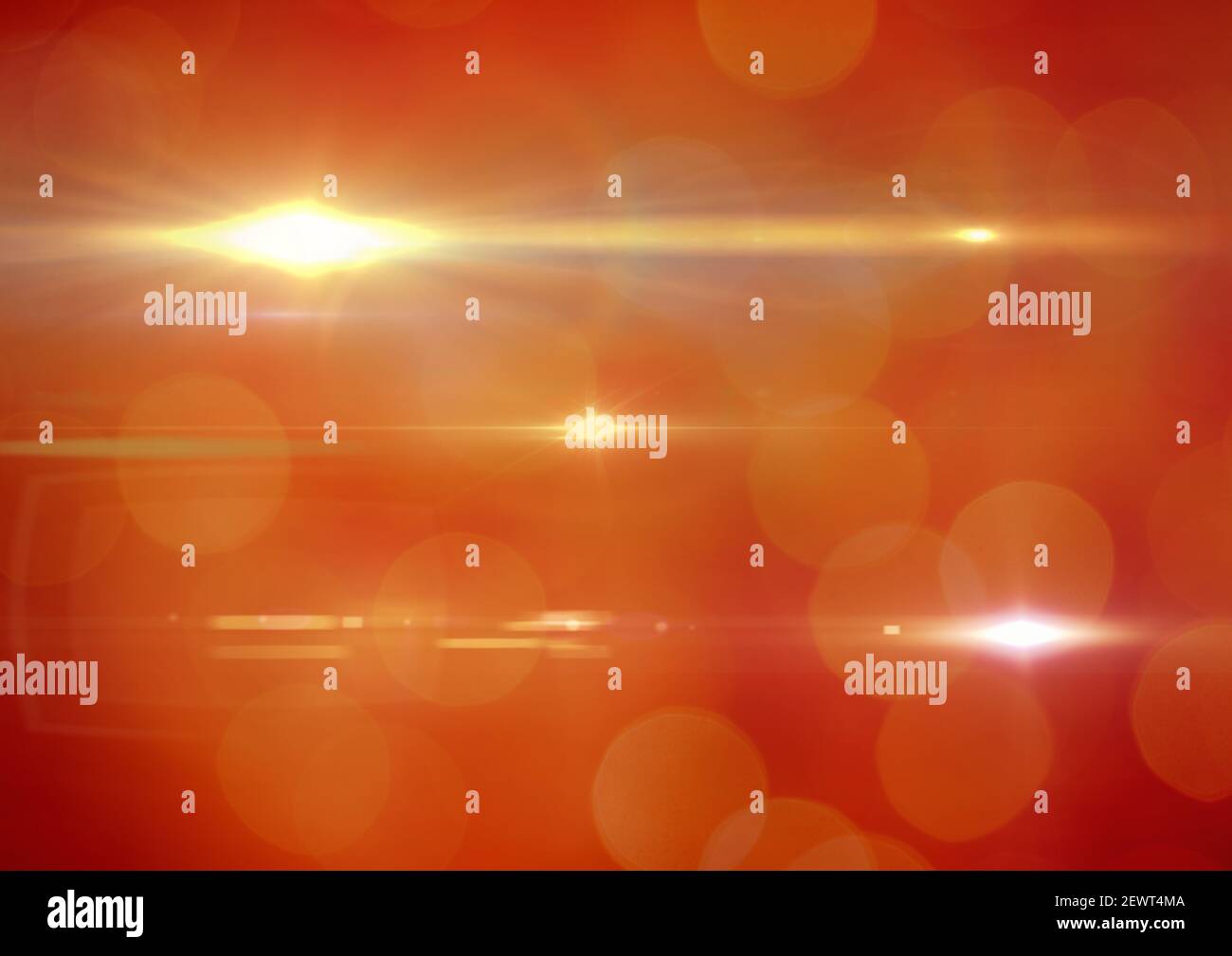 Glowing orange spots of light and light trails over orange background ...