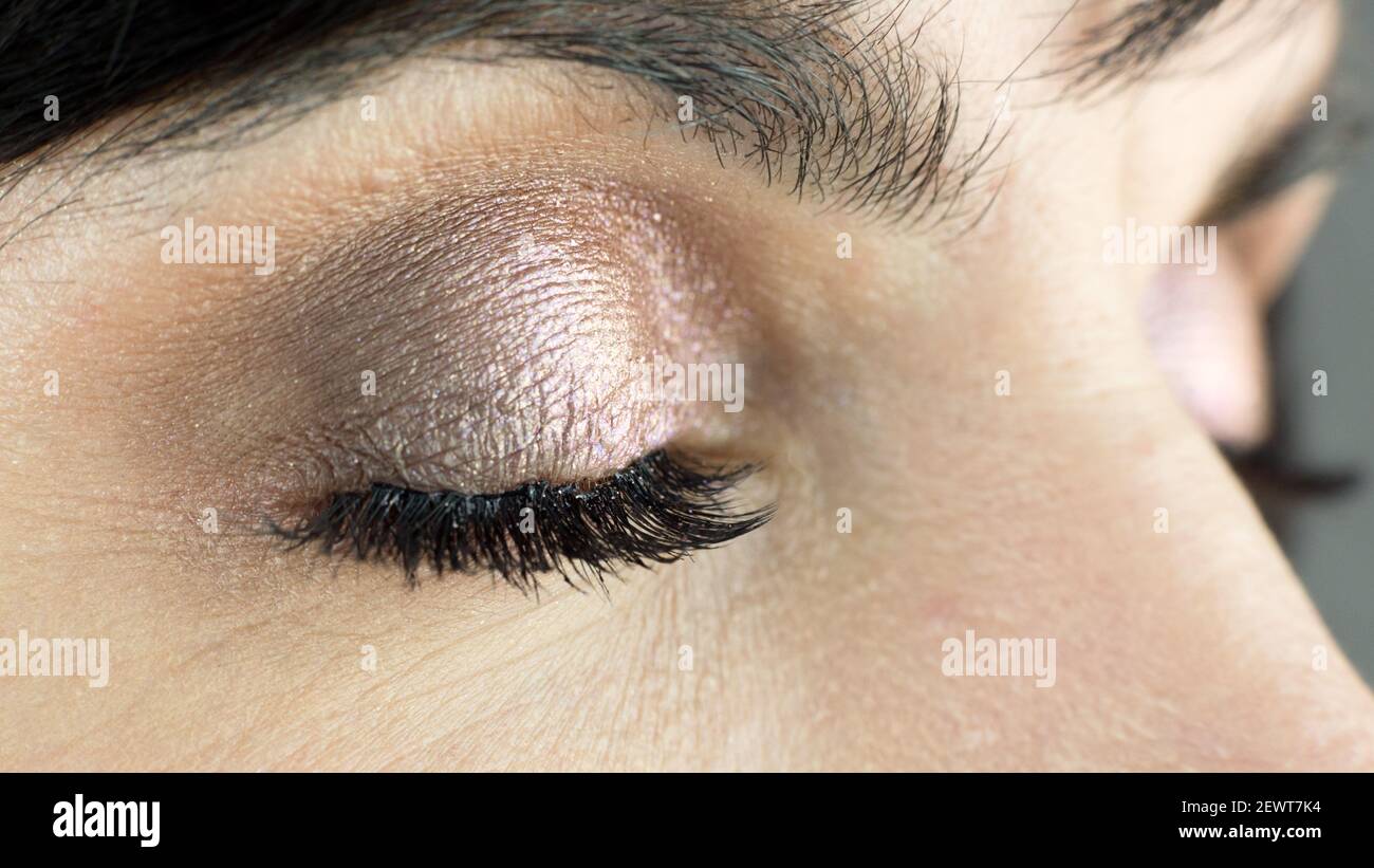 Closed female eye, drooping eyelashes, gray background.Close-up Stock ...