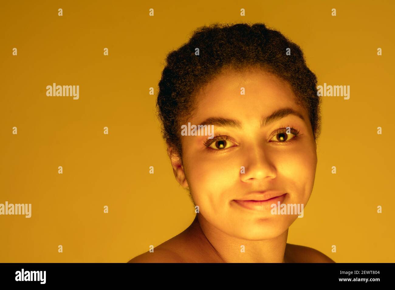 Smiley. Beautiful african-american woman's portrait isolated on yellow ...