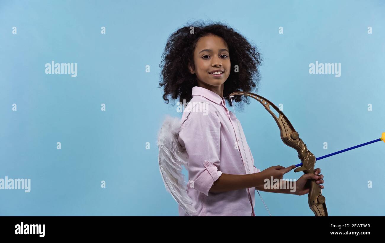 happy african american girl with wings holding crossbow isolated on ...
