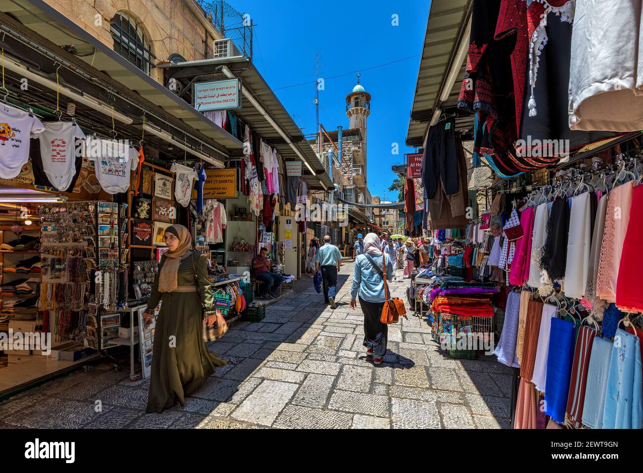 People walking on narrow street among typical arab shops on famous ...