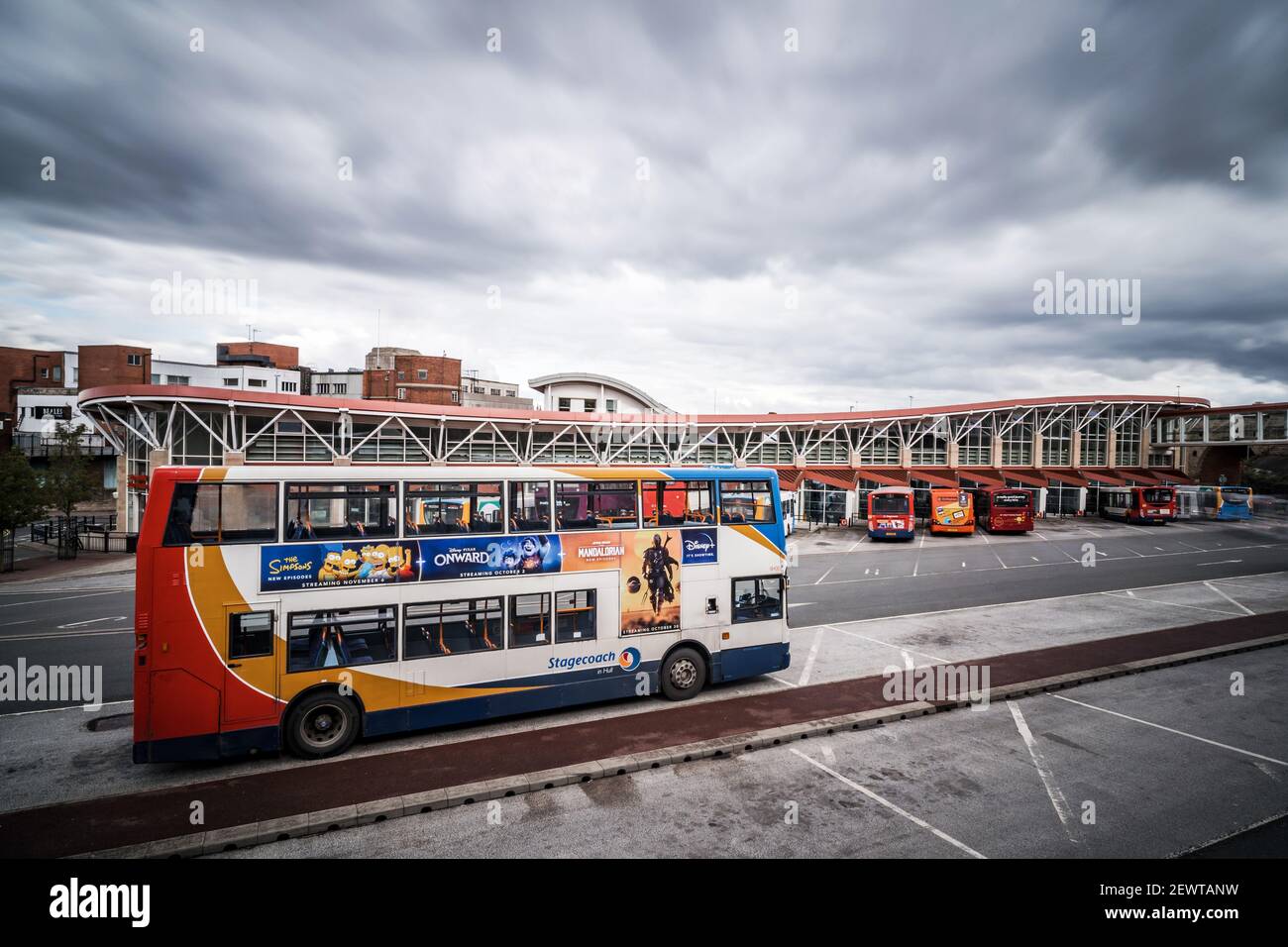 New modern bus station in centre of village with dramatic storm sky ...