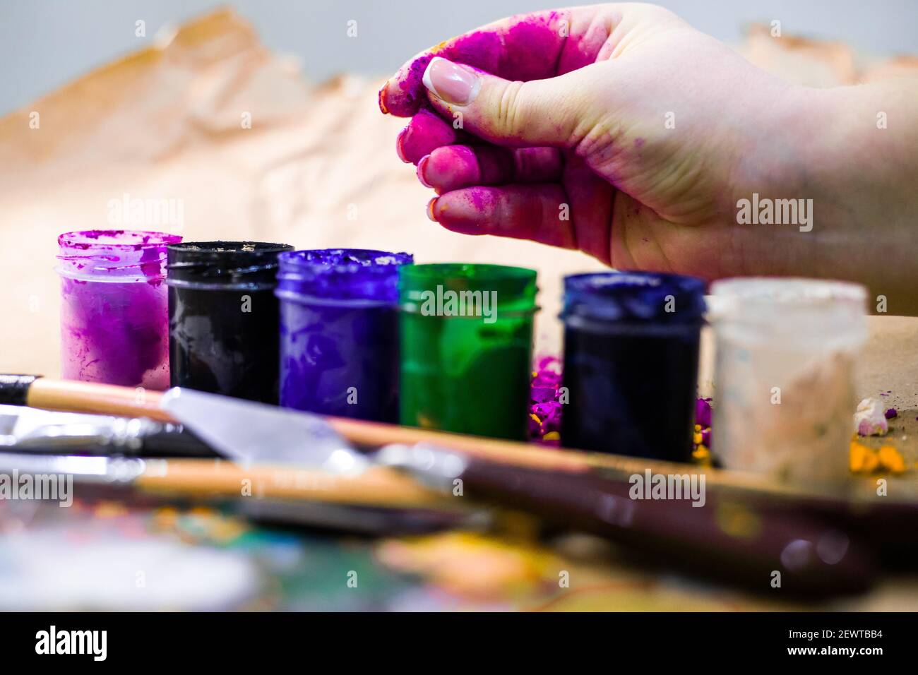 Watercolor powder in the hand of the woman who paints. Multicolored ...