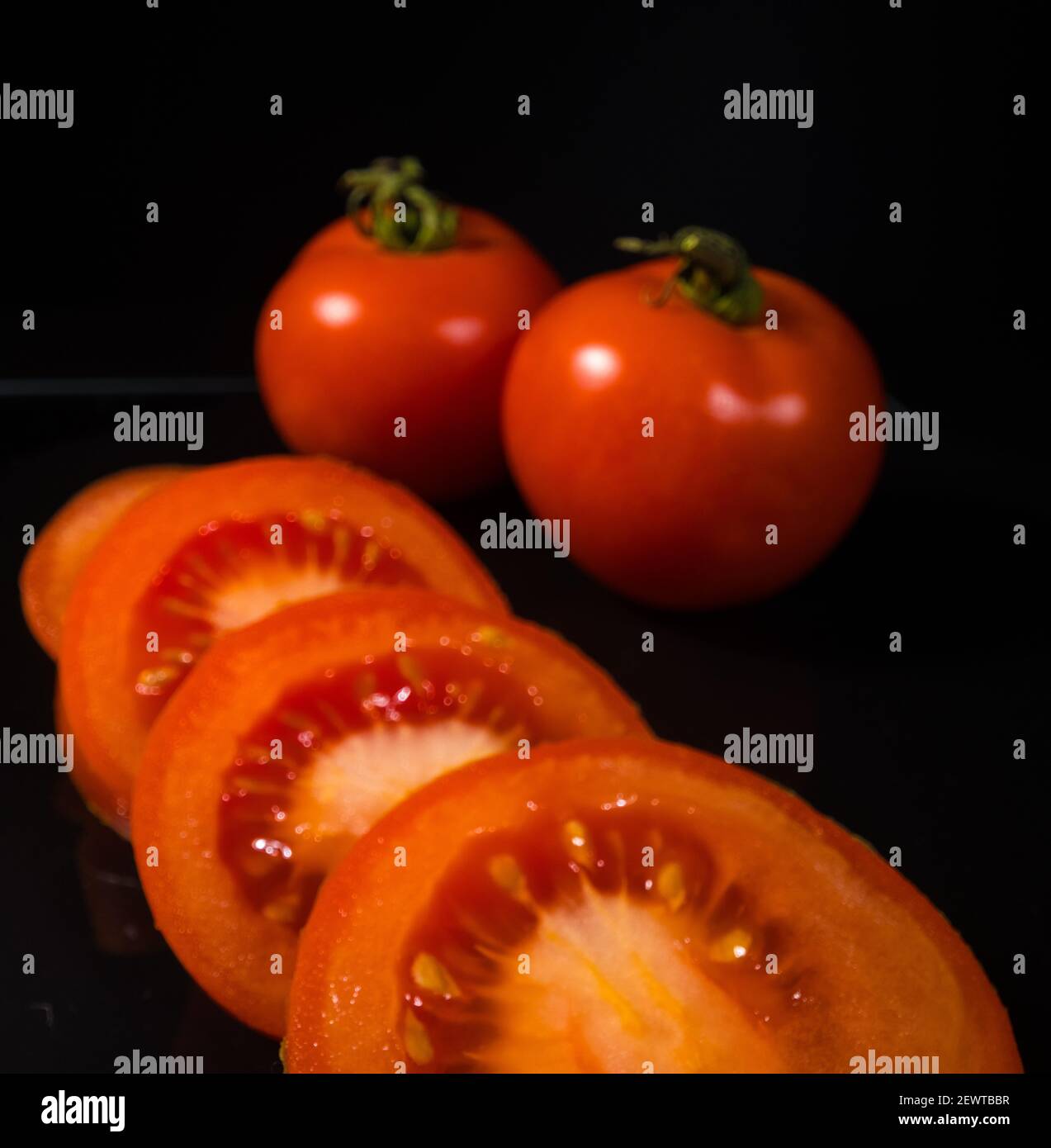 Cut fresh tomatoes into slices Stock Photo - Alamy