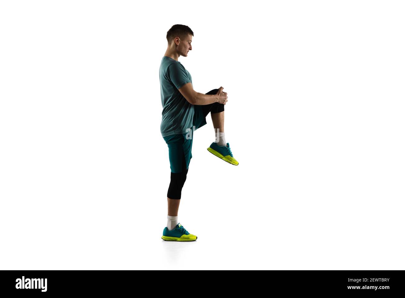 Stretching. Young caucasian male model in action, motion isolated on ...