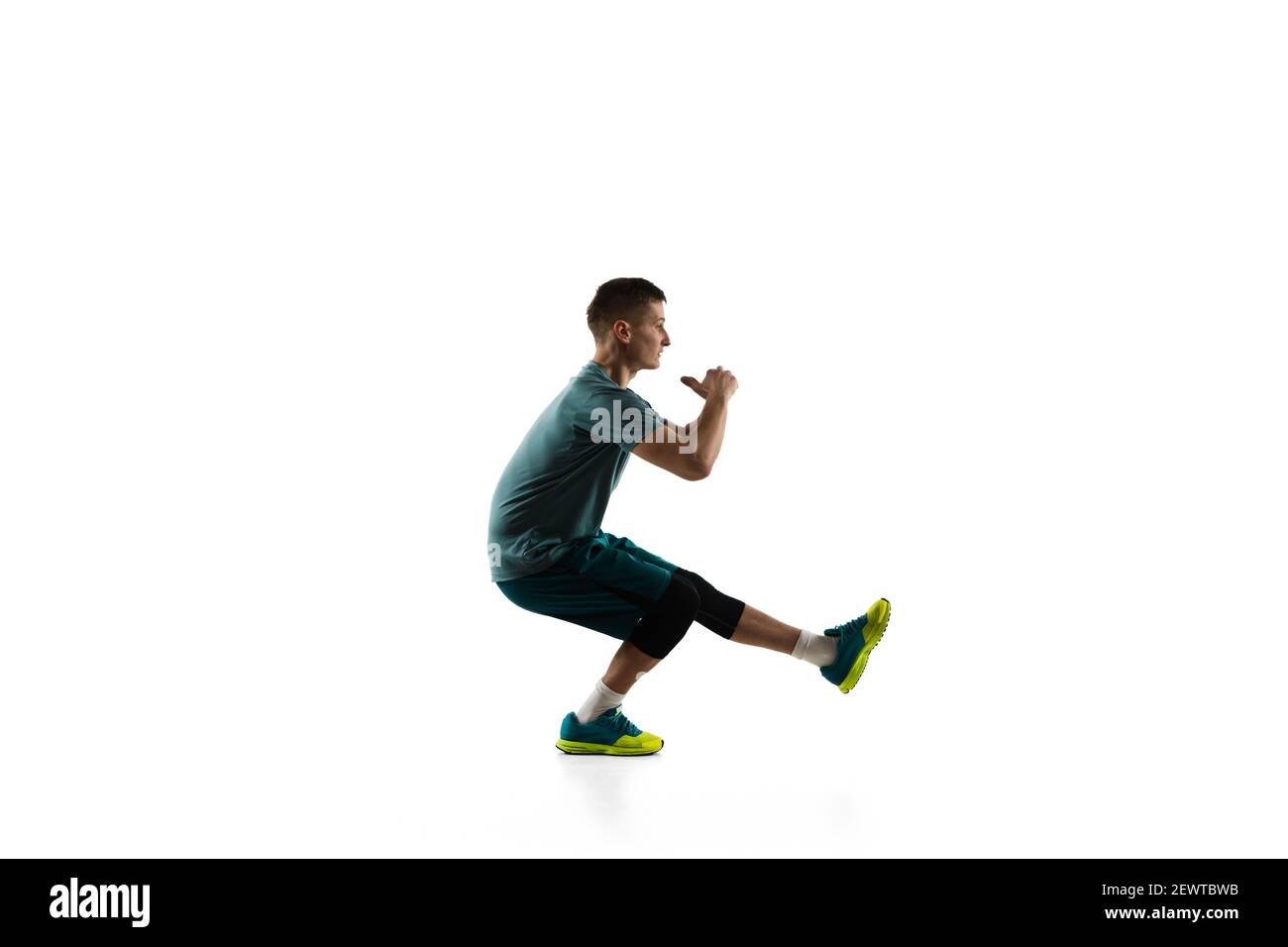 Stretching. Young caucasian male model in action, motion isolated on ...