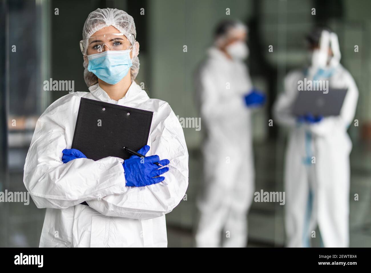 Disease control employees in protective clothing during coronavirus ...