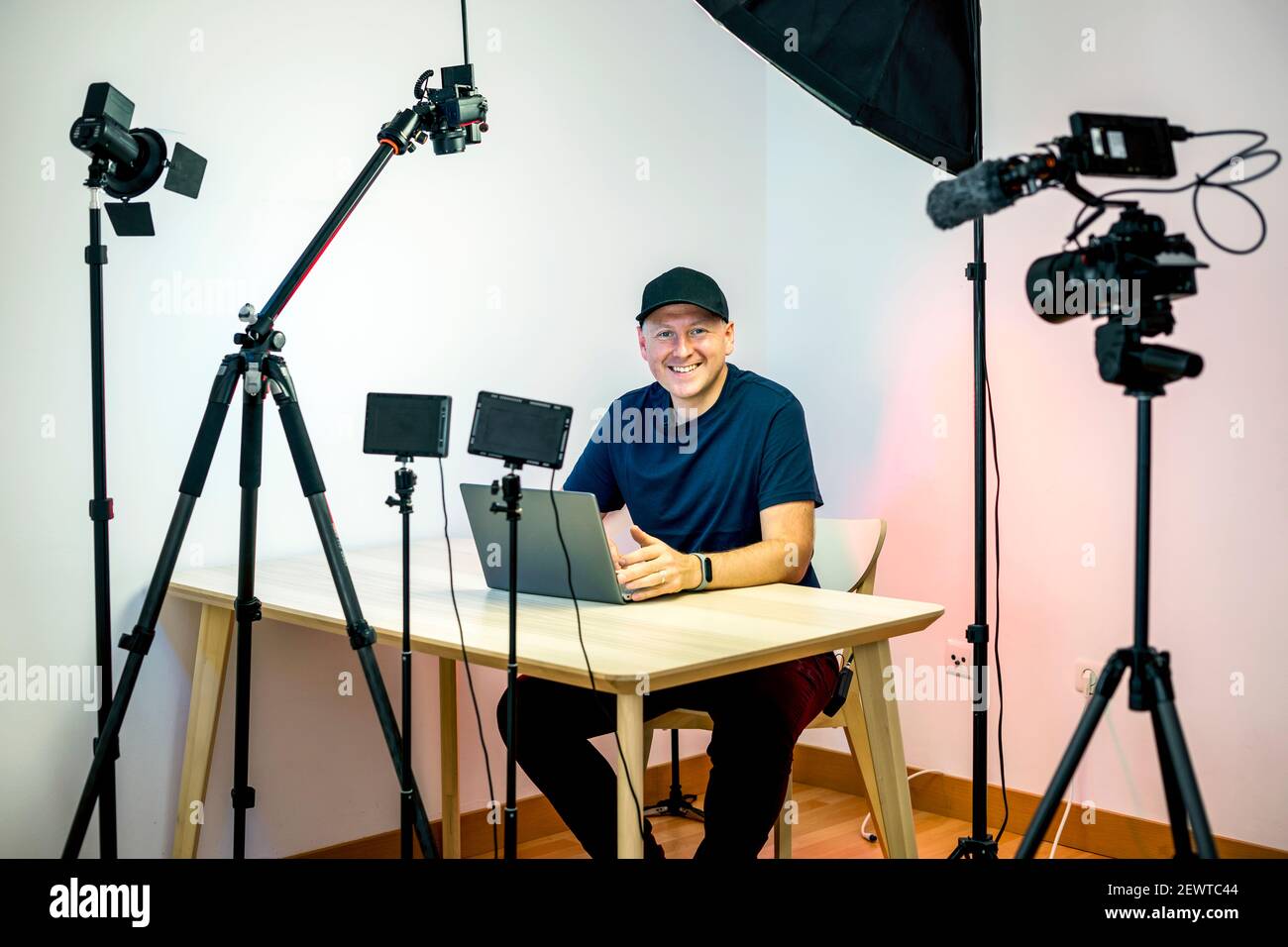 An influencer with a laptop creating and recording content in his ...