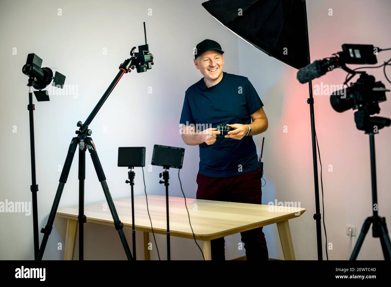 An influencer with a lens creating and recording content in his studio ...