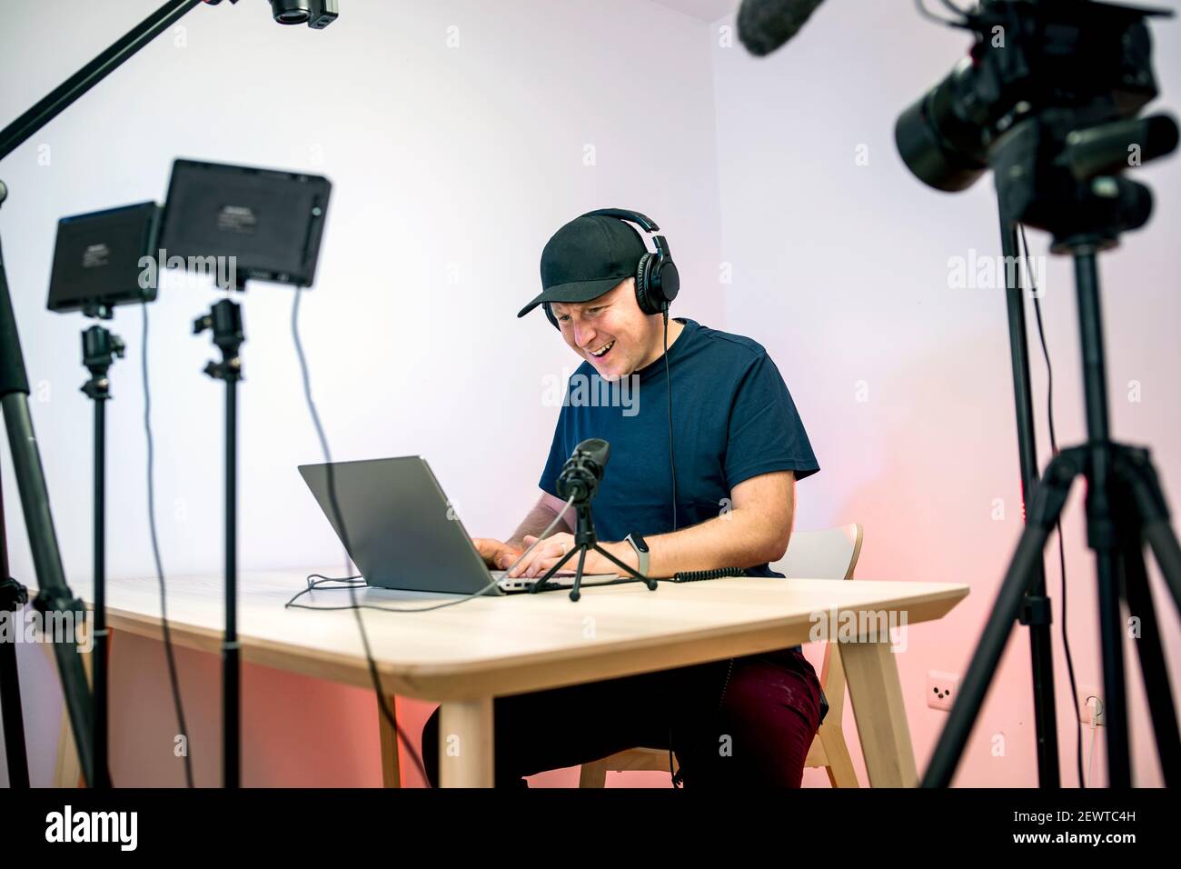 Gamer, streamer, or Youtuber streaming and recording in his home studio ...