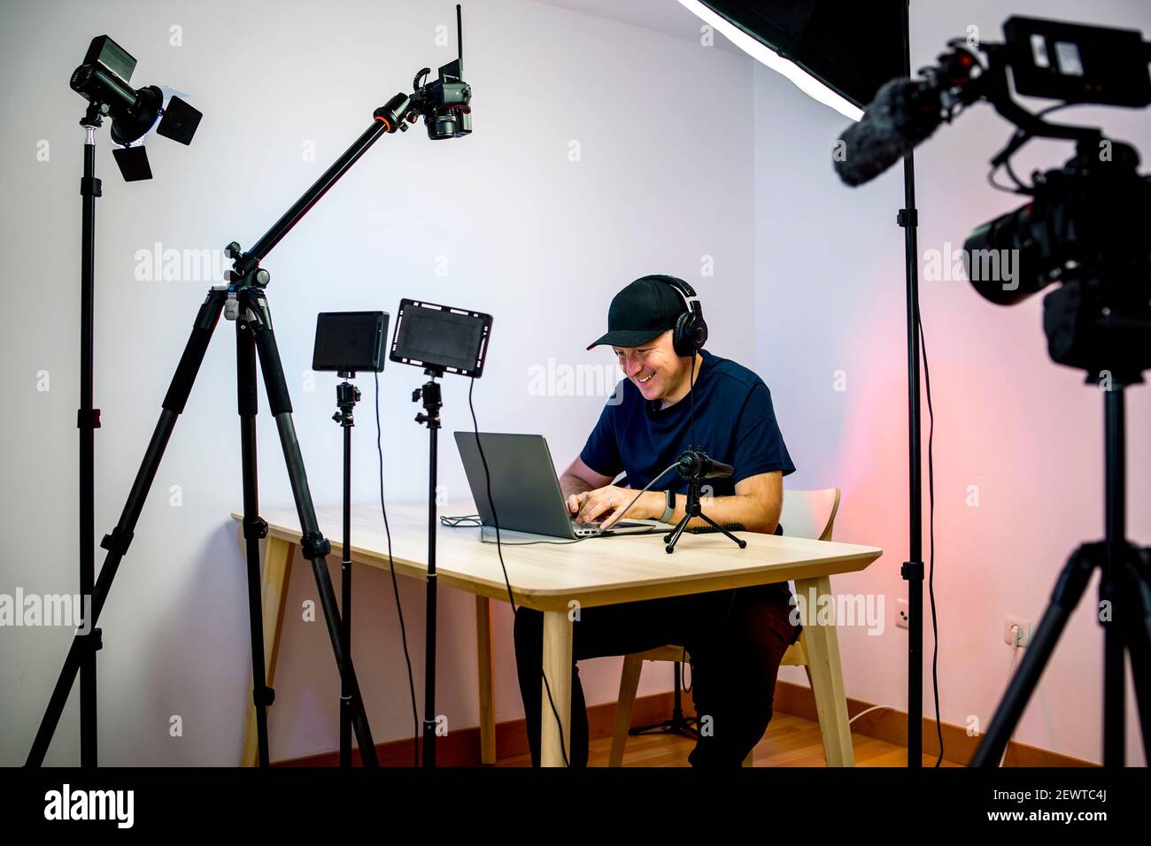 Gamer, streamer, or Youtuber streaming and recording in his home studio ...