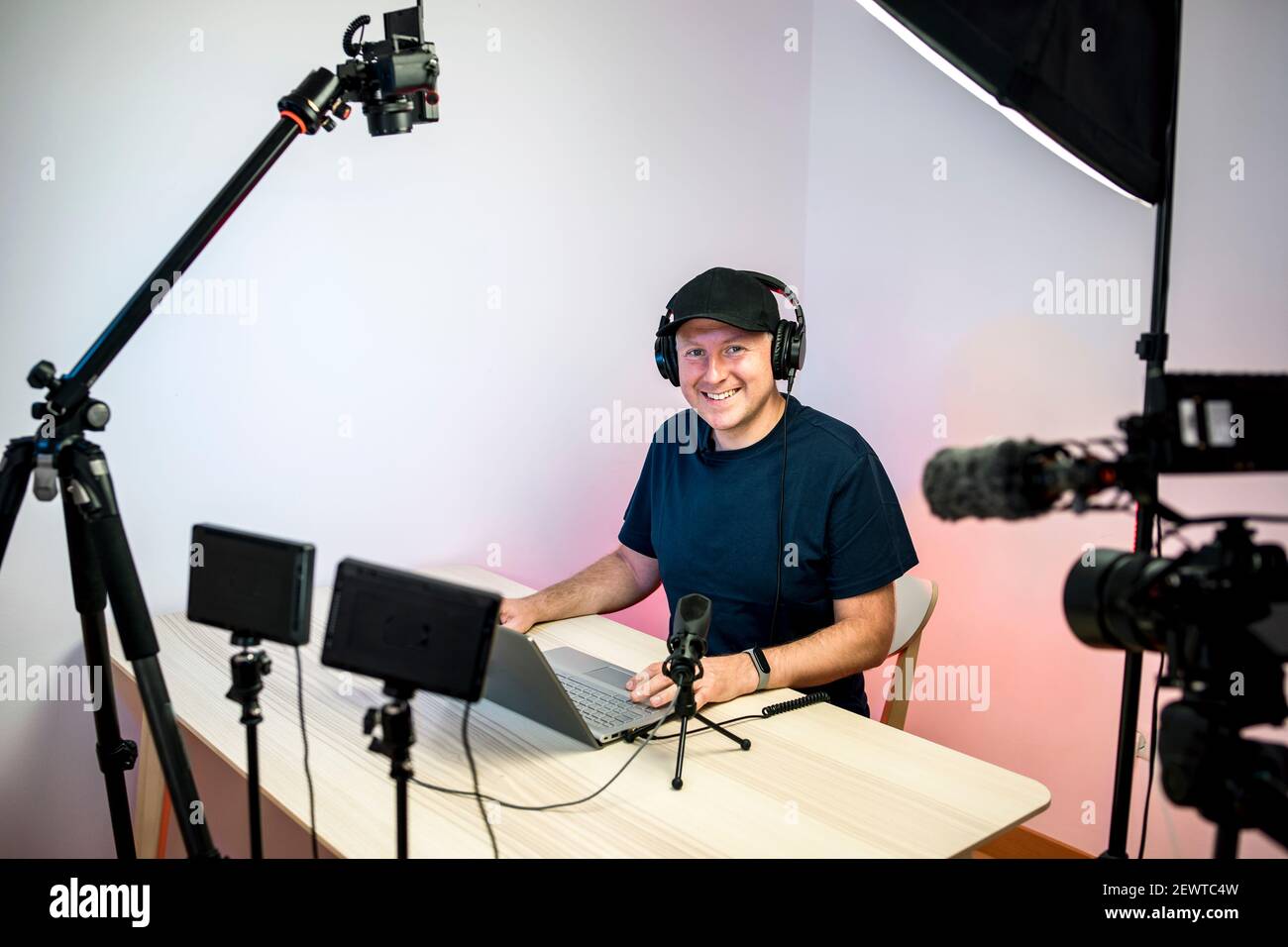 Gamer, streamer, or Youtuber streaming and recording in his home studio ...