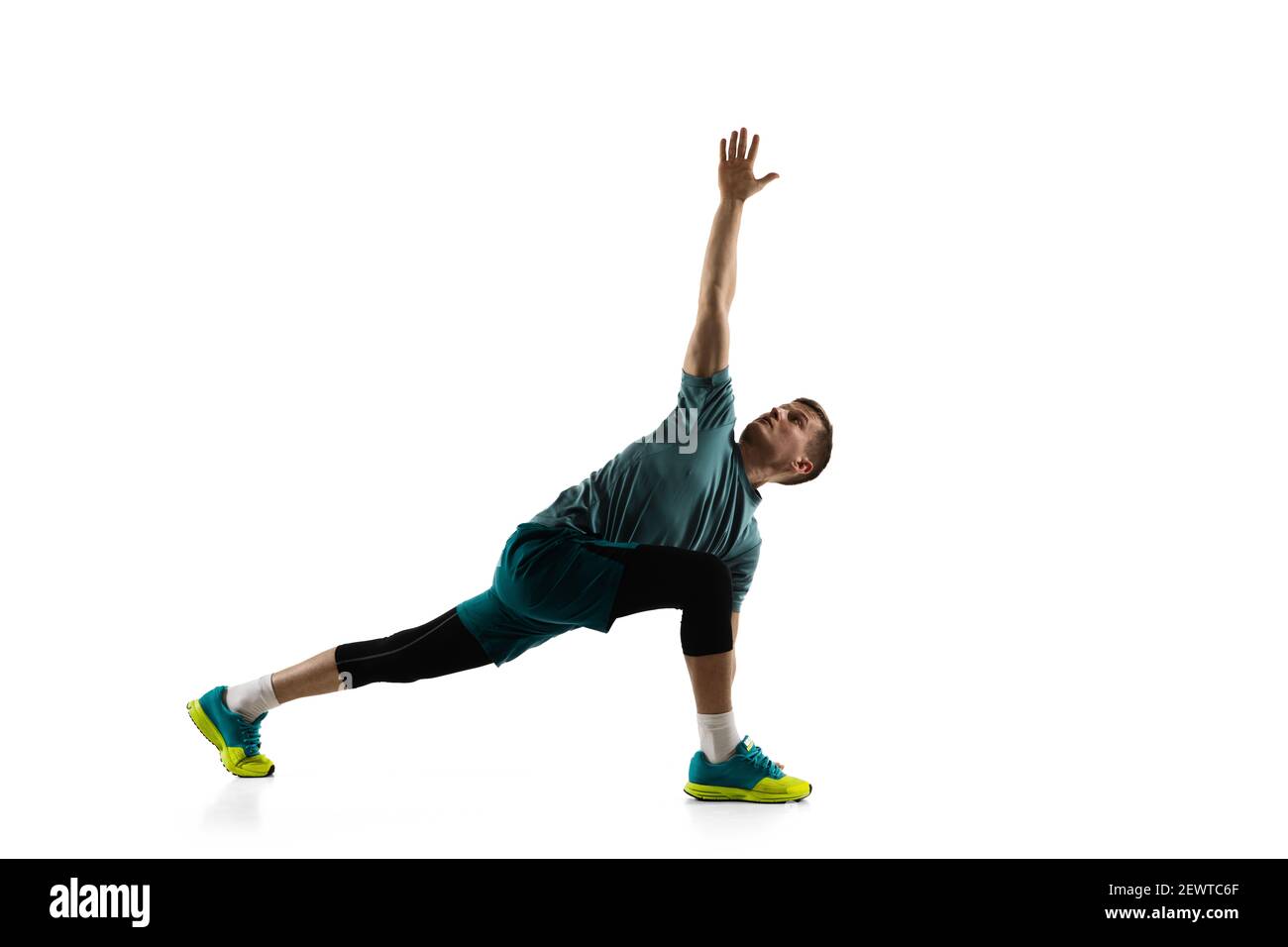 Stretching. Young caucasian male model in action, motion isolated on ...