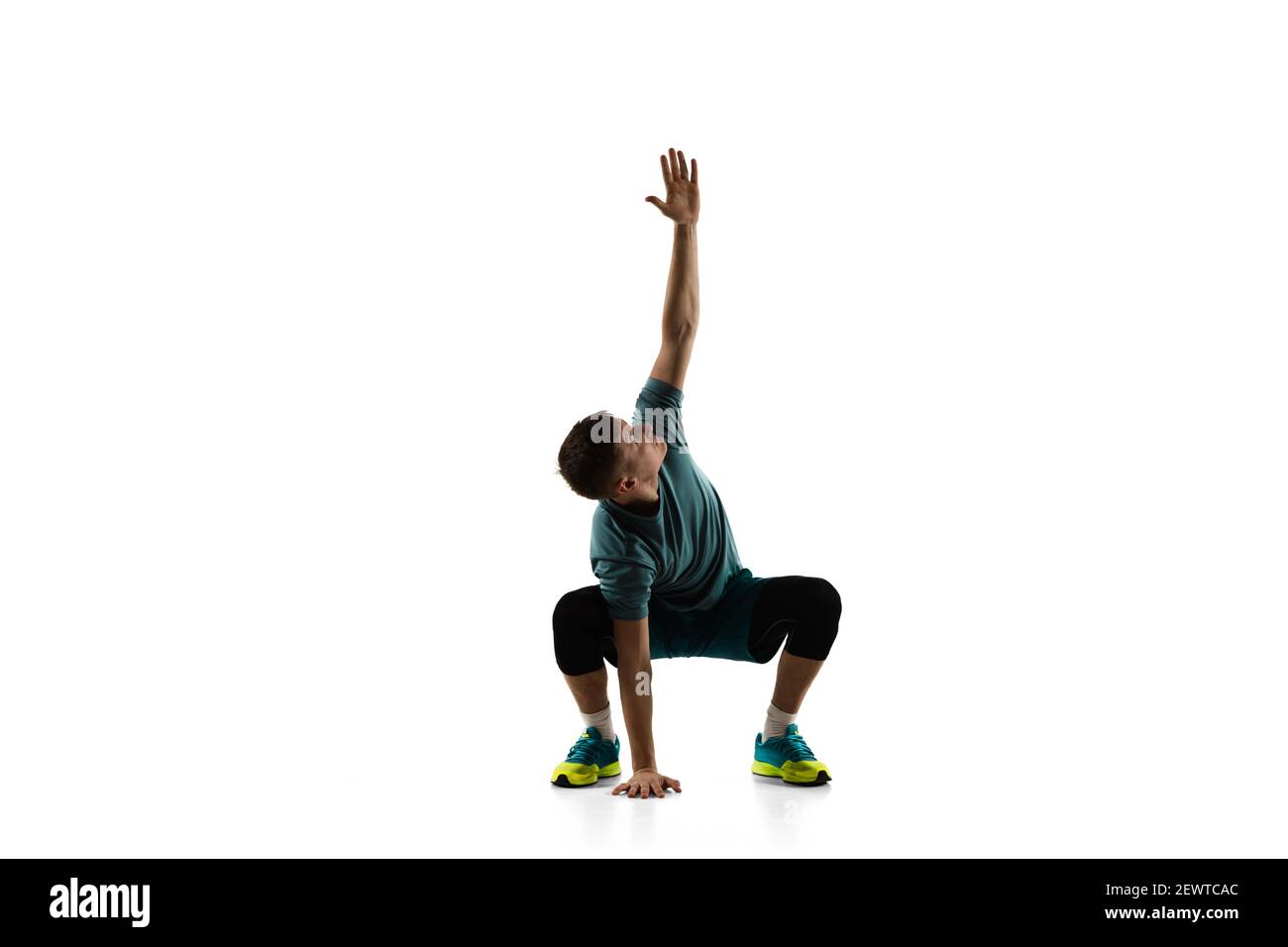 Stretching. Young caucasian male model in action, motion isolated on ...