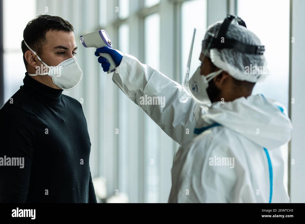 Staff man at medical office used the digital thermometer to measure the ...