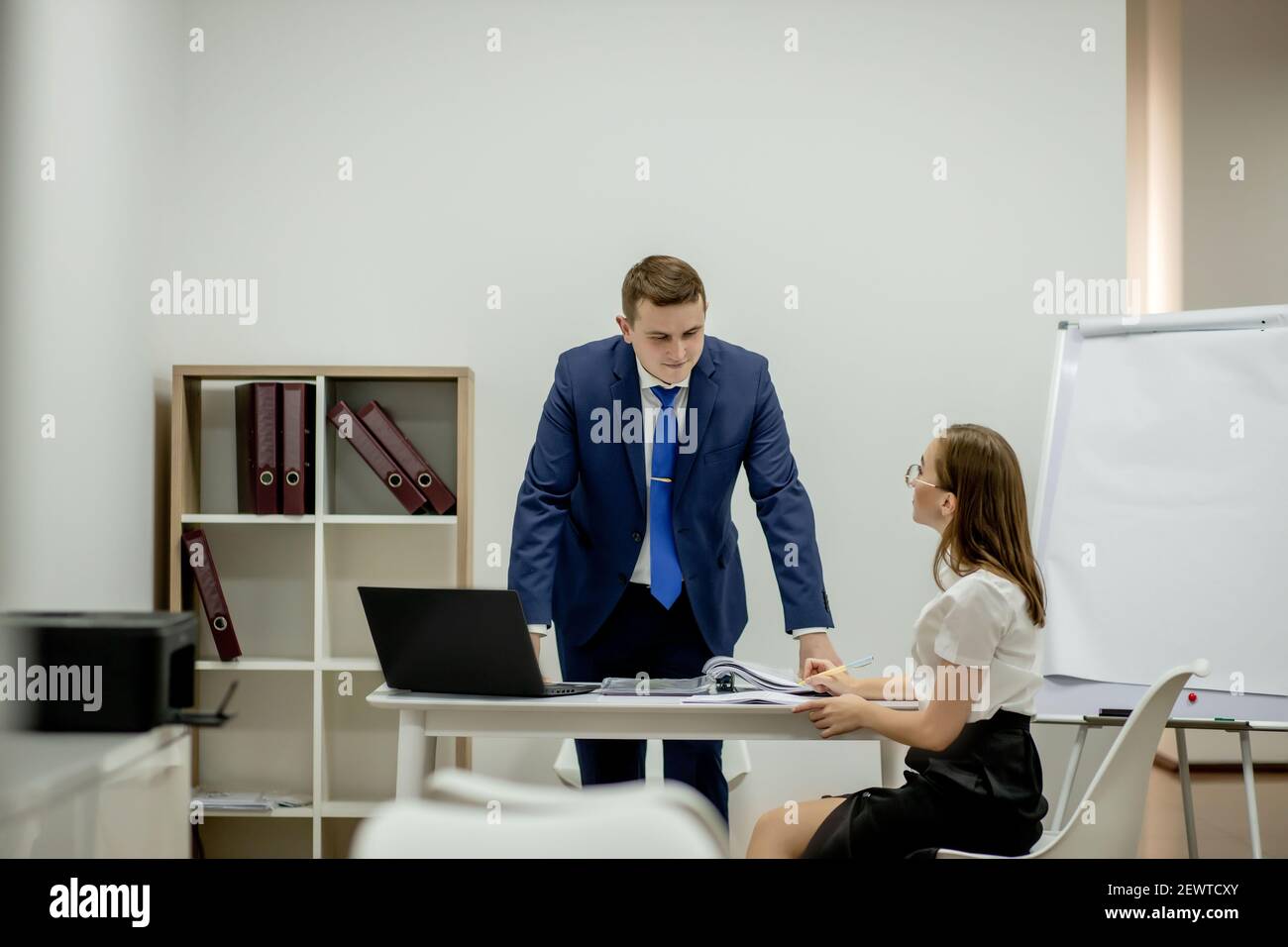 Manager and secretary working in the office Stock Photo - Alamy