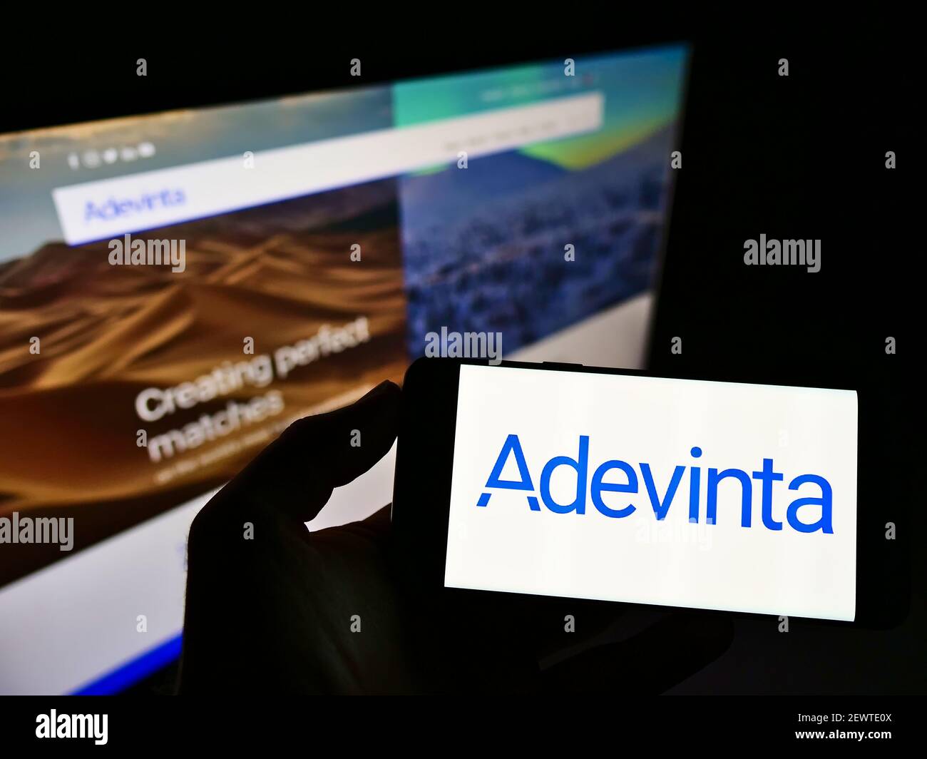 Person holding smartphone with logo of Norwegian e-commerce company ...