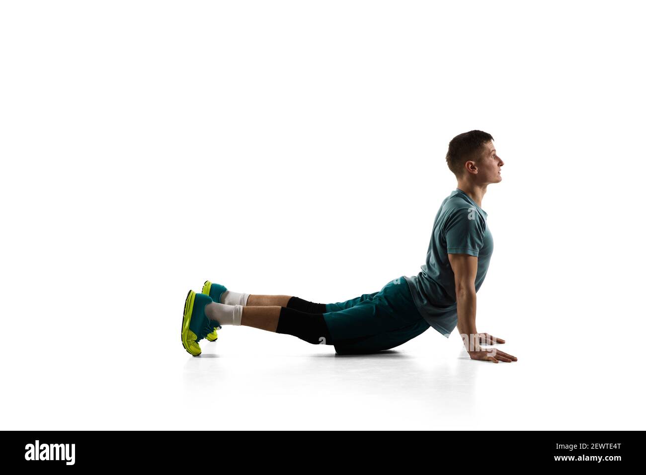 Stretching. Young caucasian male model in action, motion isolated on ...